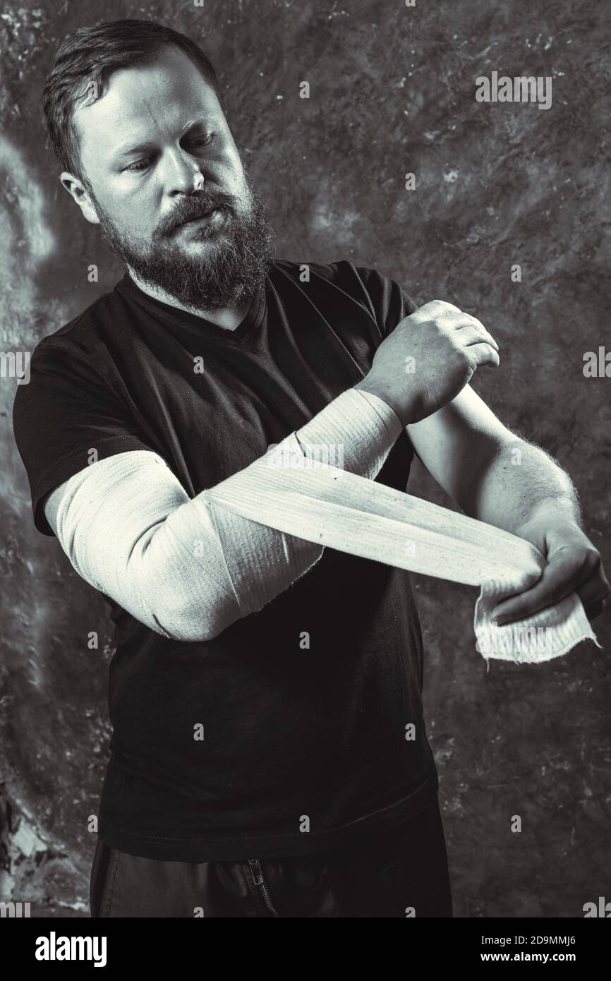 Matured man with bandaged hand studio portrait Stock Photo - Alamy