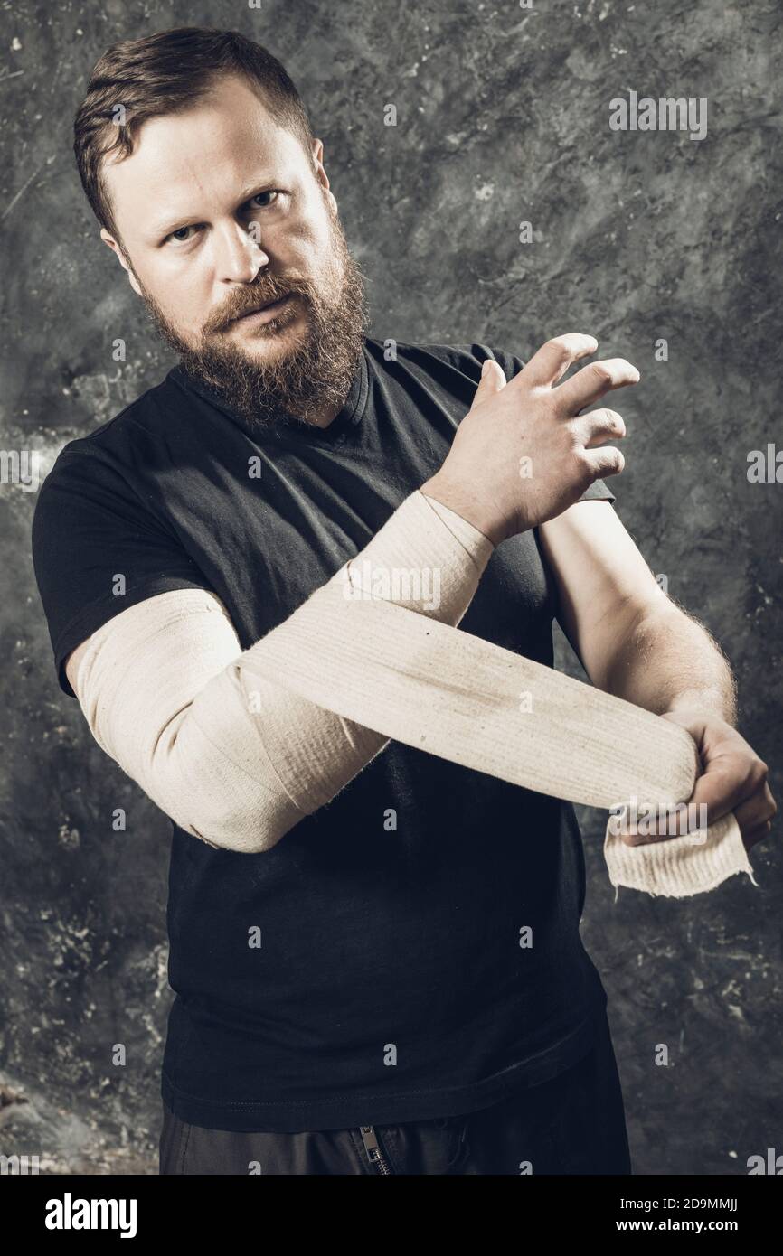 Matured man with bandaged hand studio portrait Stock Photo - Alamy