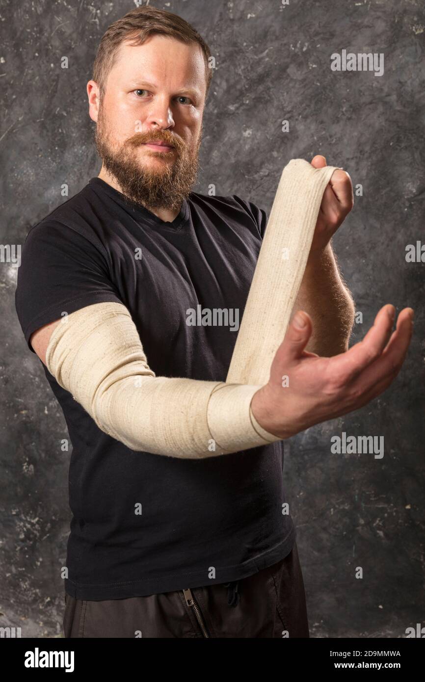 Matured man with bandaged hand studio portrait Stock Photo - Alamy