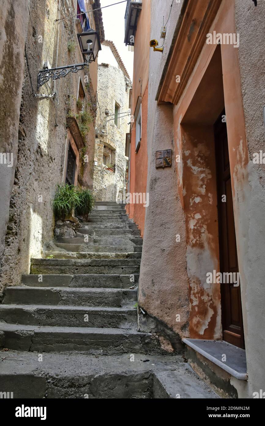 A narrow street among the old houses of Scalea, a rural village in the ...