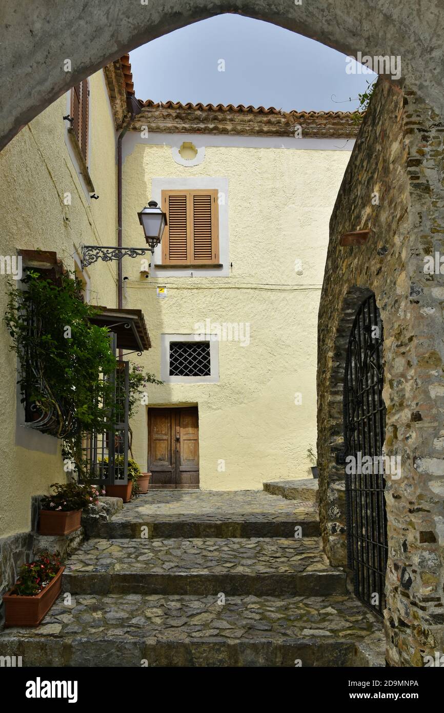 A narrow street among the old houses of Scalea, a rural village in the ...