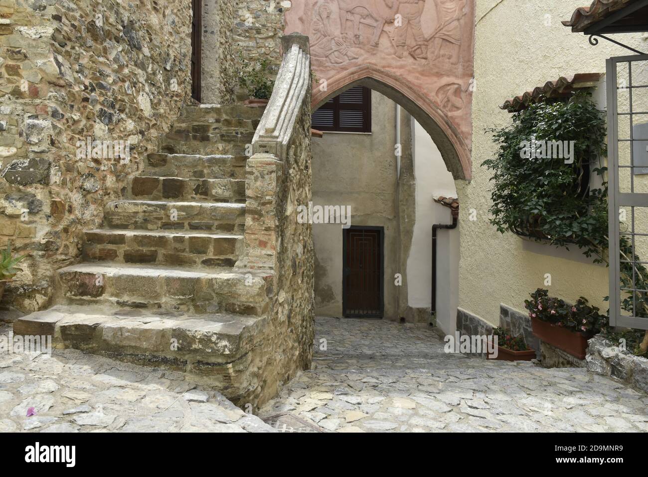 A narrow street among the old houses of Scalea, a rural village in the ...