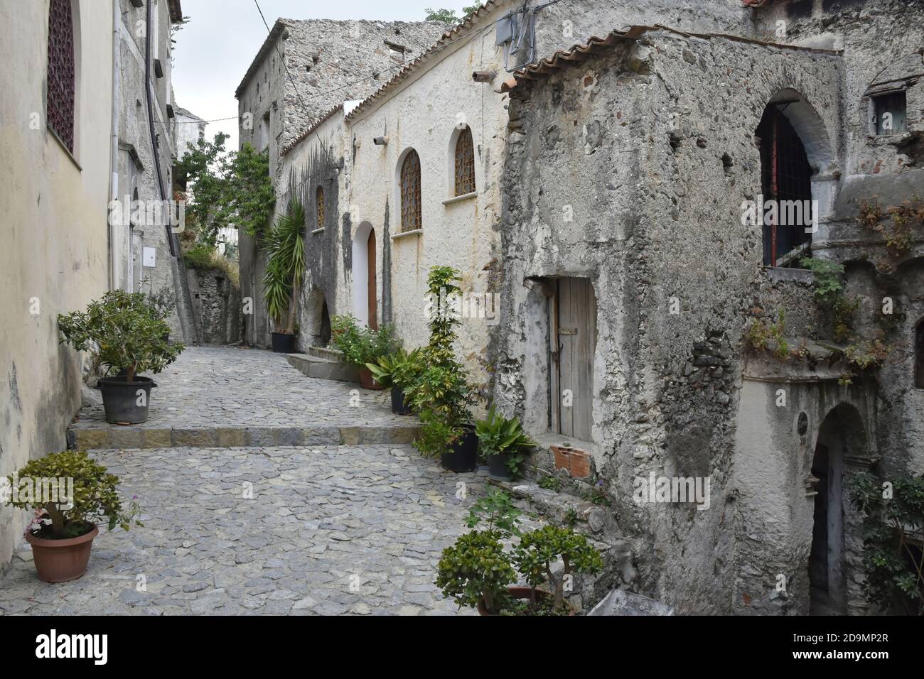 A narrow street among the old houses of Scalea, a rural village in the ...