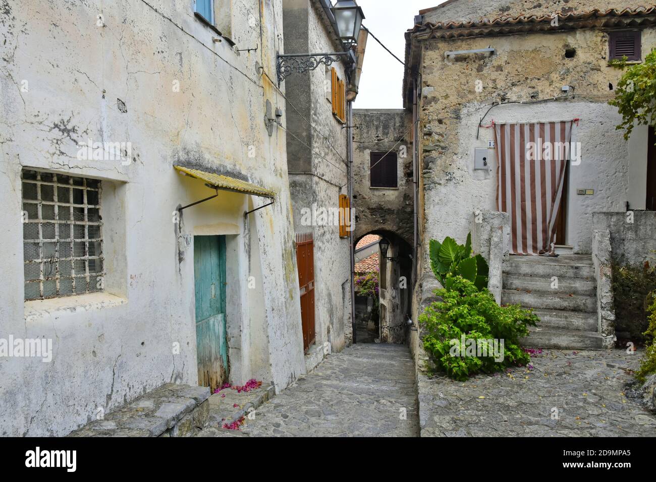 A narrow street among the old houses of Scalea, a rural village in the ...
