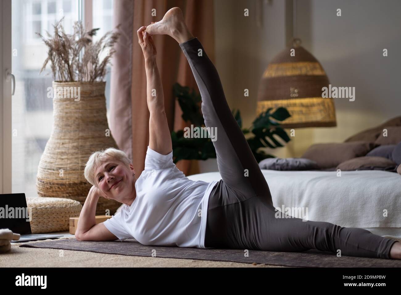 woman doing fitness workout, exercise stretching legs, Anantasana or ...