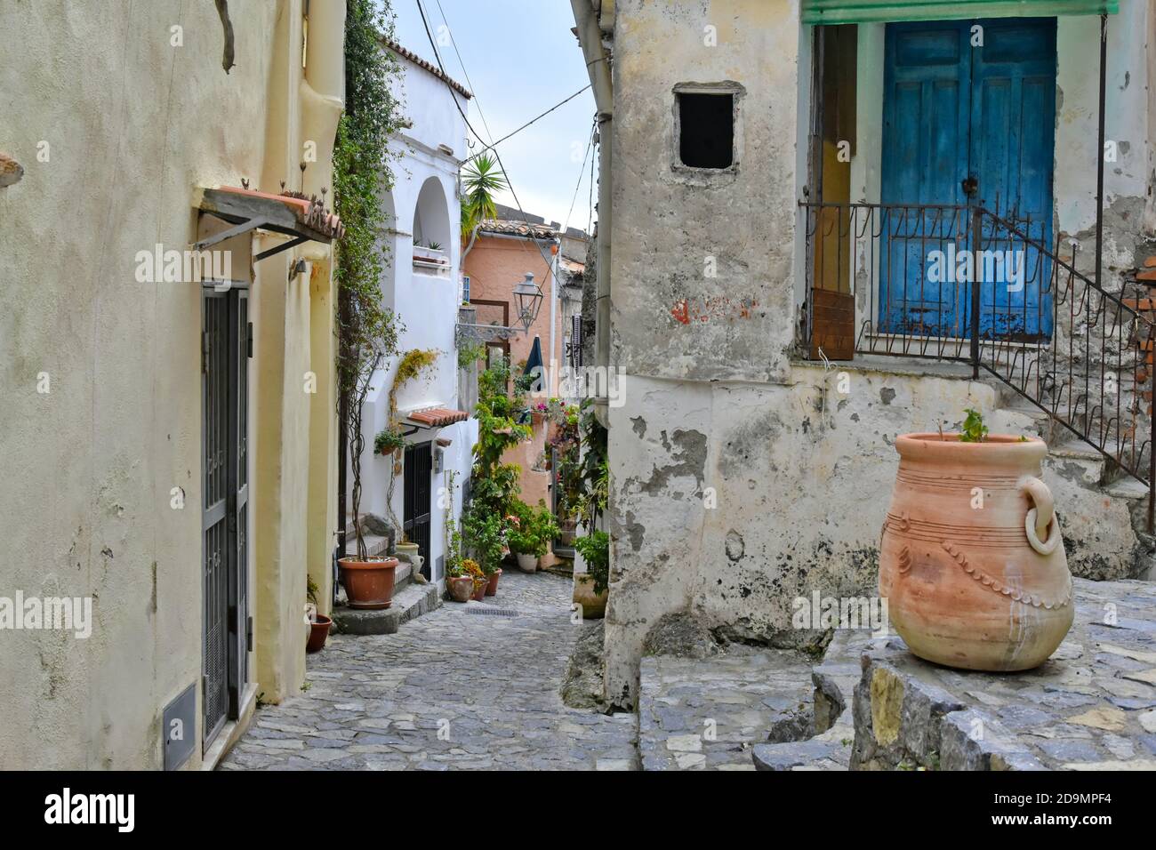 A narrow street among the old houses of Scalea, a rural village in the ...