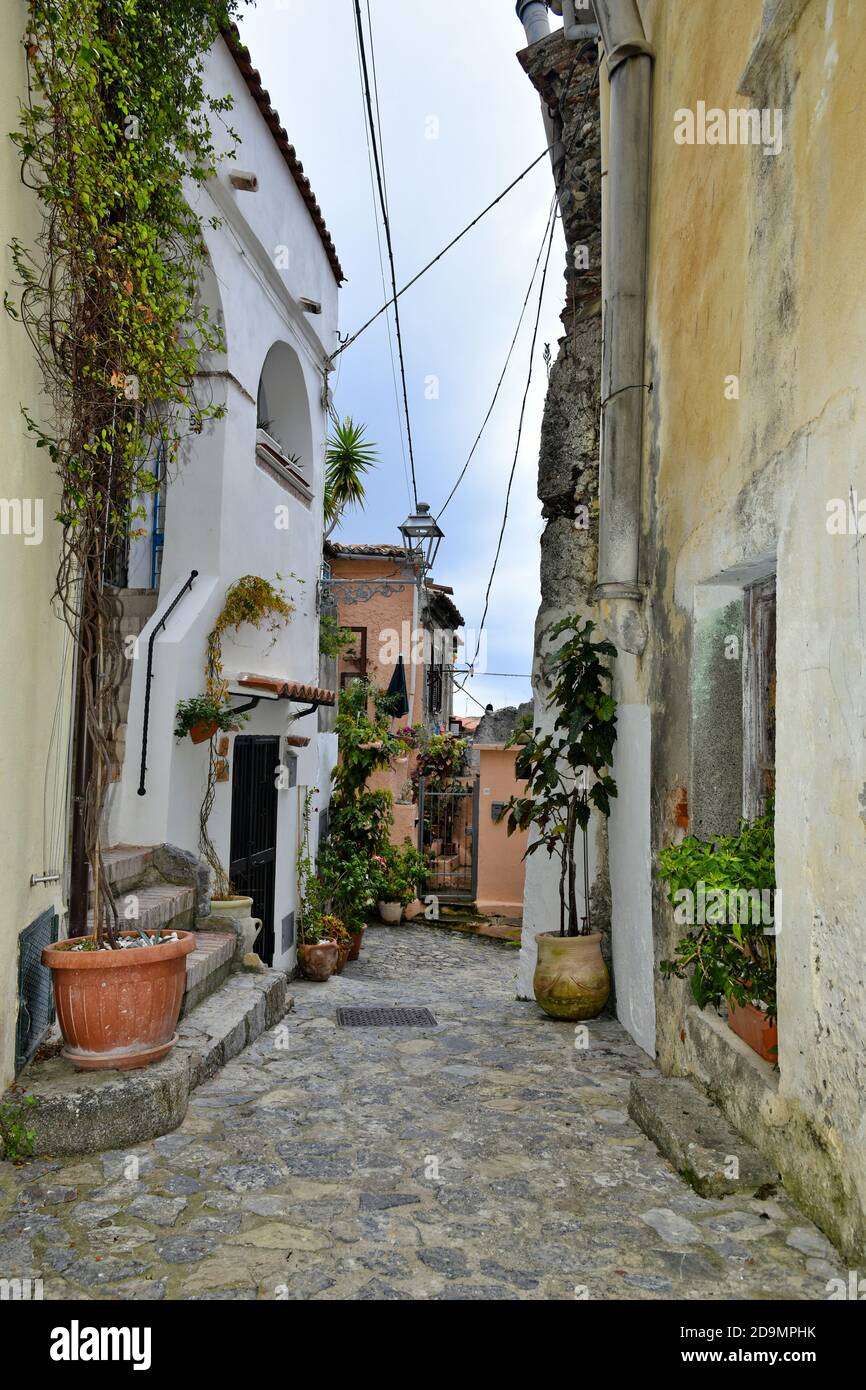A narrow street among the old houses of Scalea, a rural village in the ...
