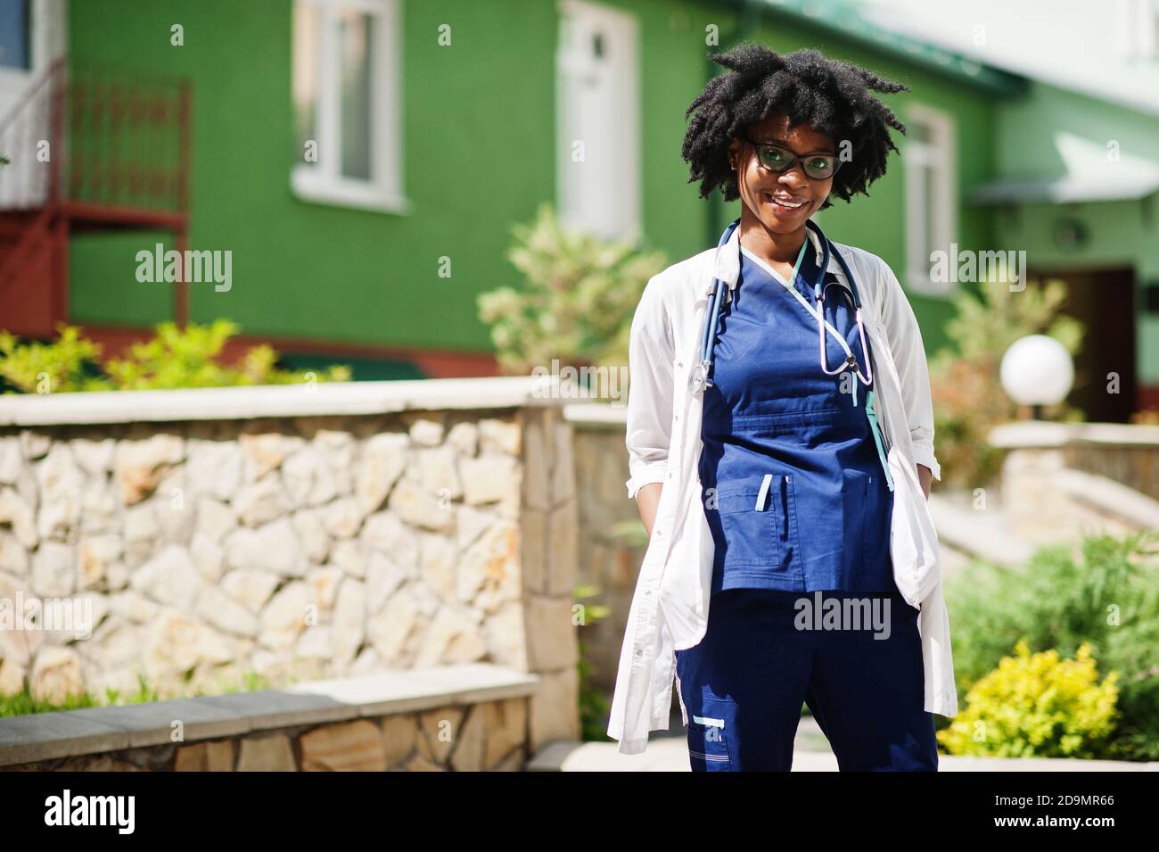 Portrait of African American female doctor with stethoscope wearing lab ...