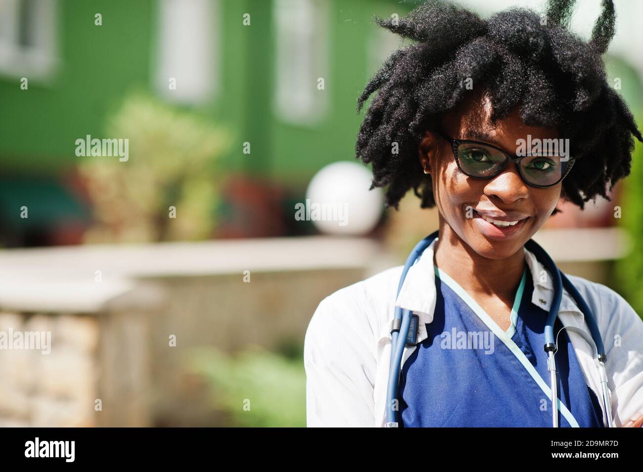 Portrait of African American female doctor with stethoscope wearing lab ...
