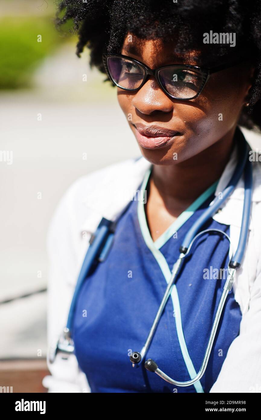 Portrait of African American female doctor with stethoscope wearing lab ...