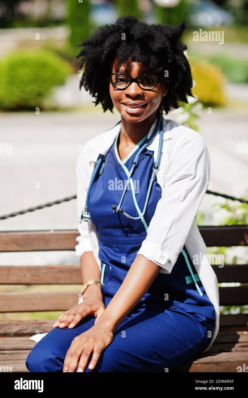 Portrait of African American female doctor with stethoscope wearing lab ...