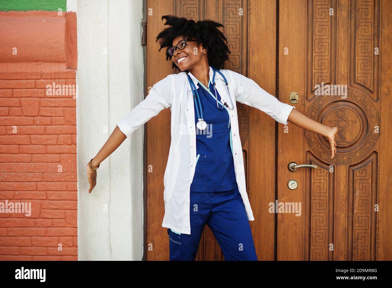 Portrait of African American female doctor with stethoscope wearing lab ...