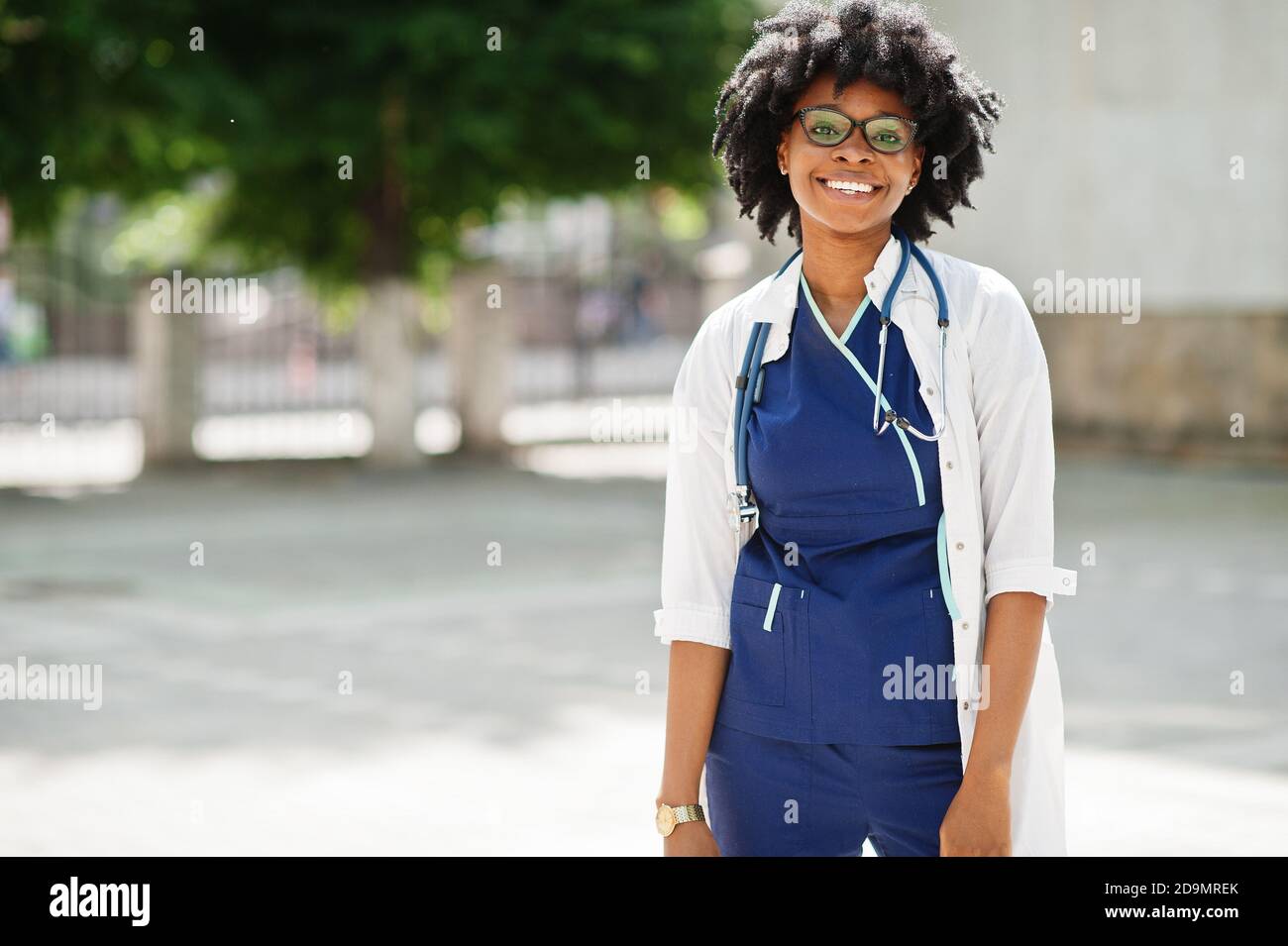 Portrait of African American female doctor with stethoscope wearing lab ...