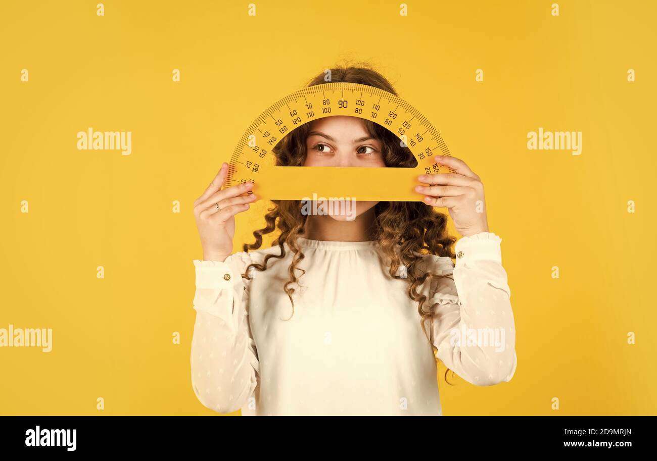 Back to school. Student learning geometry yellow background. Measure ...
