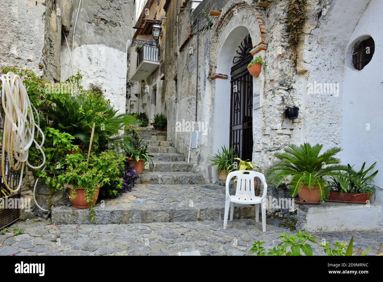 A narrow street among the old houses of Scalea, a rural village in the ...