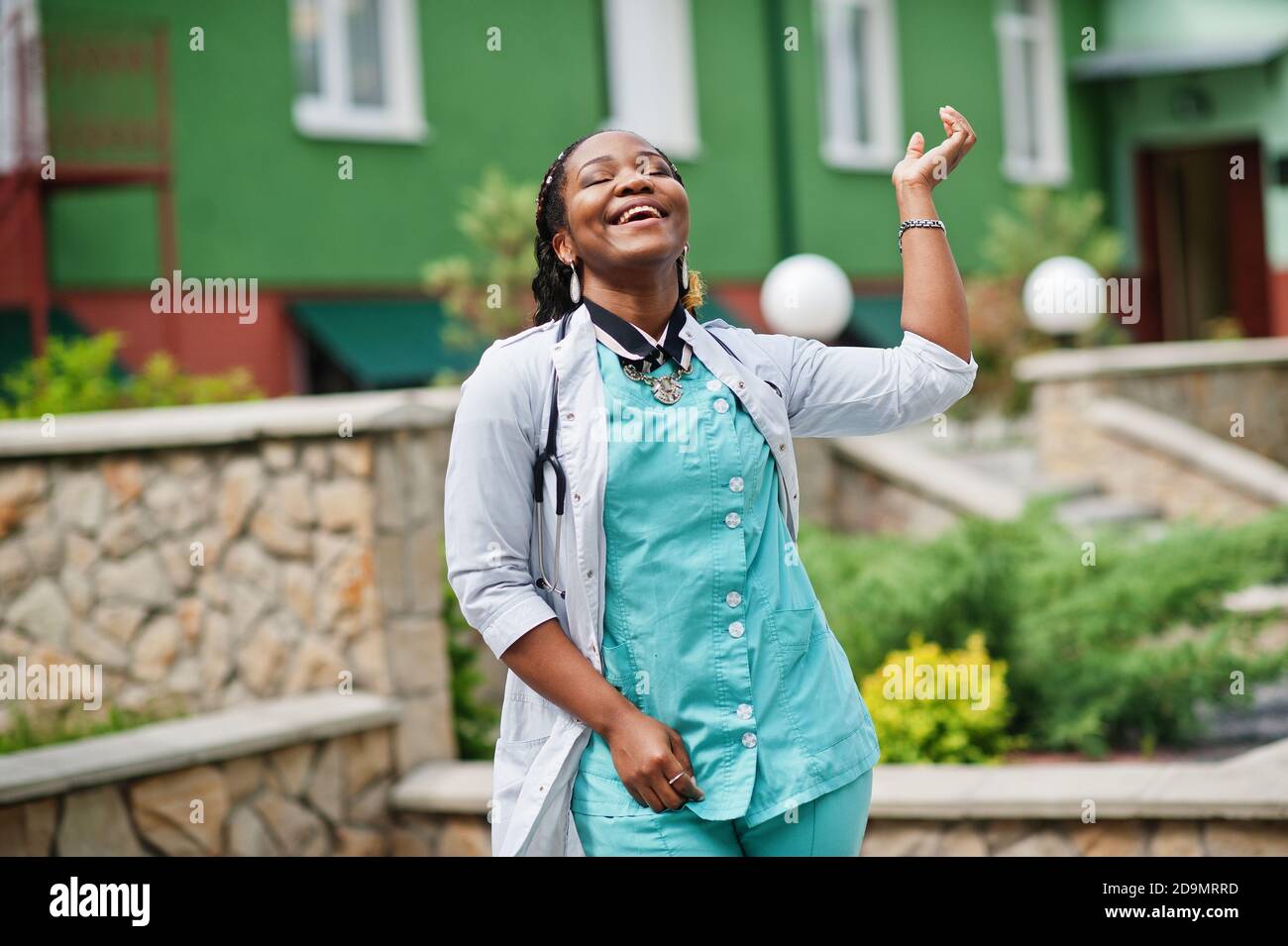 Portrait of African American female doctor with stethoscope wearing lab ...
