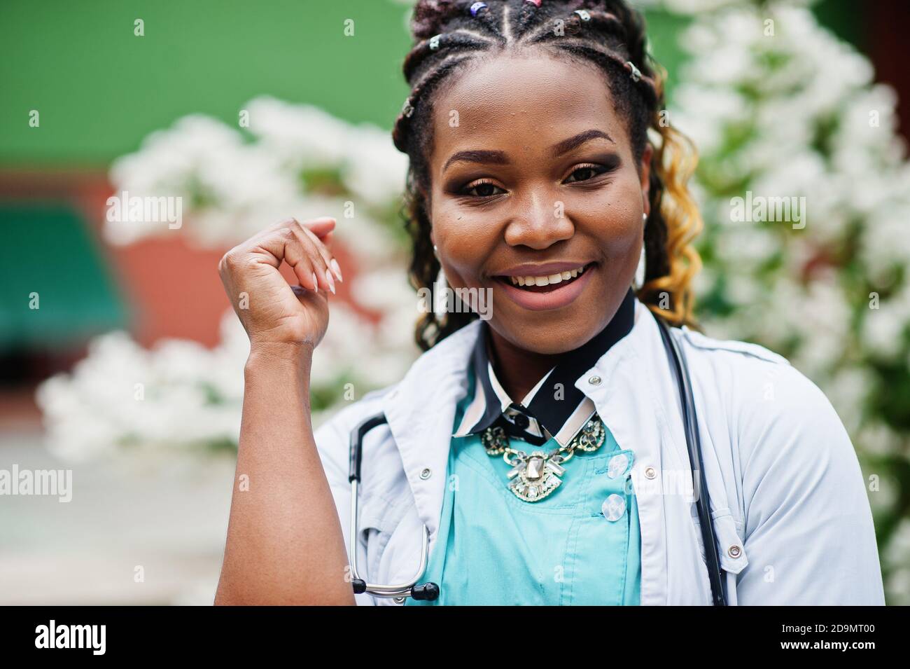 Portrait of African American female doctor with stethoscope wearing lab ...