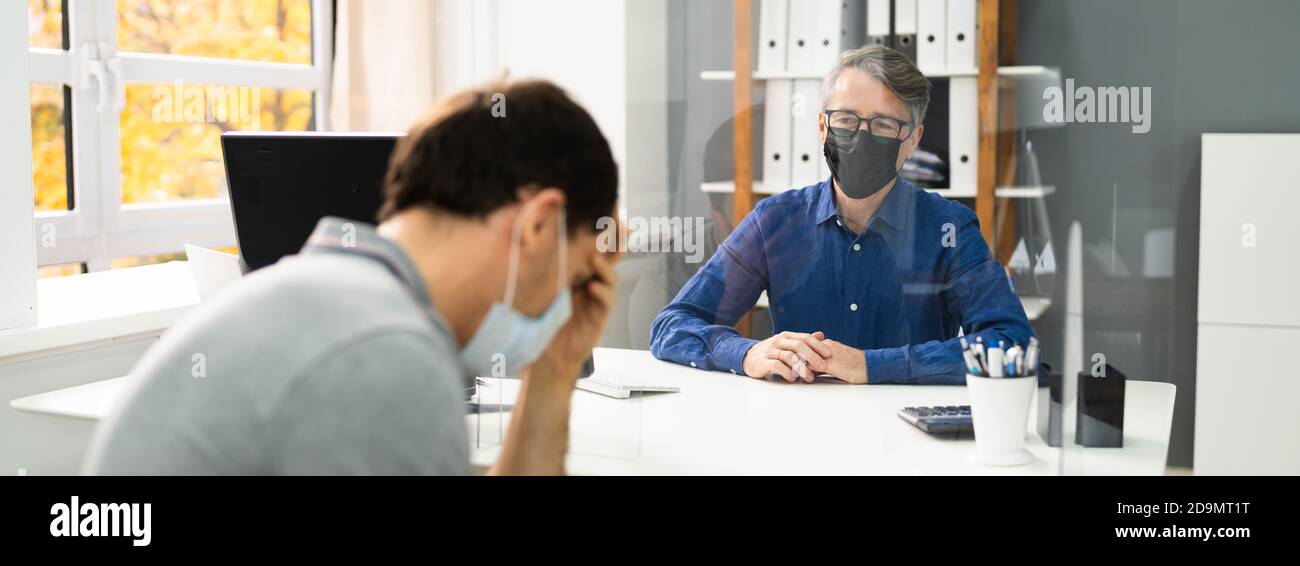 Sad Man In Meeting With Consultant In Bank With Sneeze Guard Stock ...