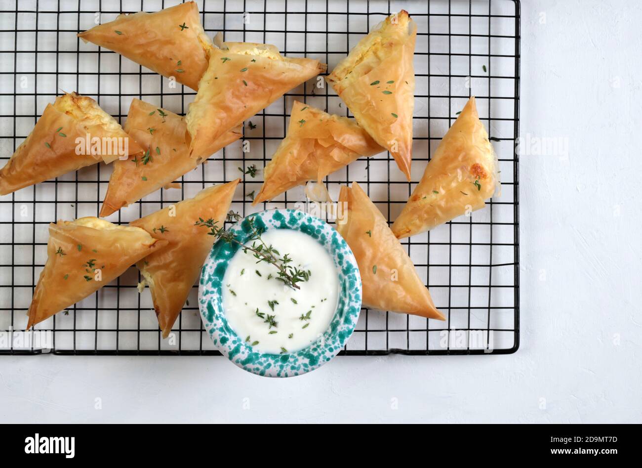 Greek cuisine. Tiropita, greek feta cheese triangle pies on white ...