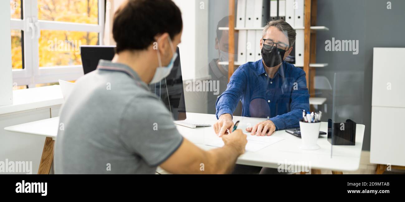 Social Distancing With Client Using Face Mask Stock Photo - Alamy