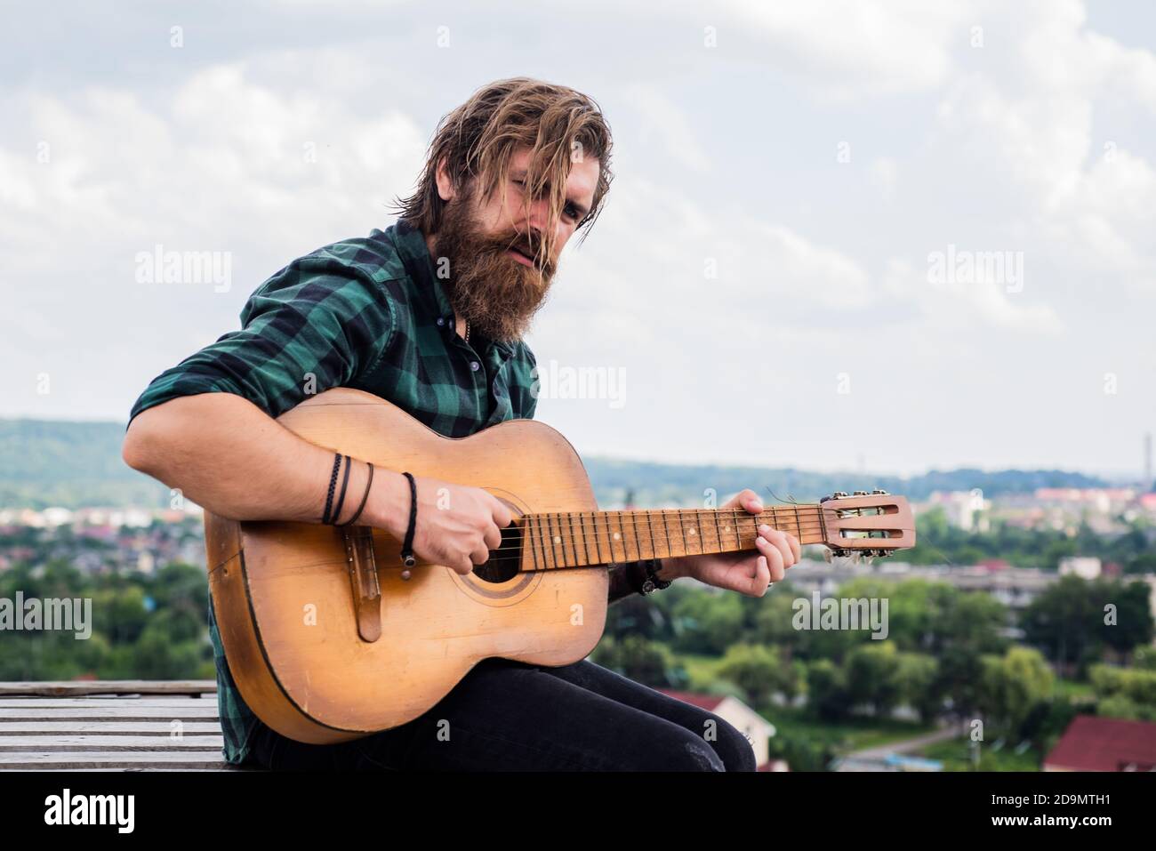 be famous. brutal caucasian guy playing guitar. country music. bearded ...