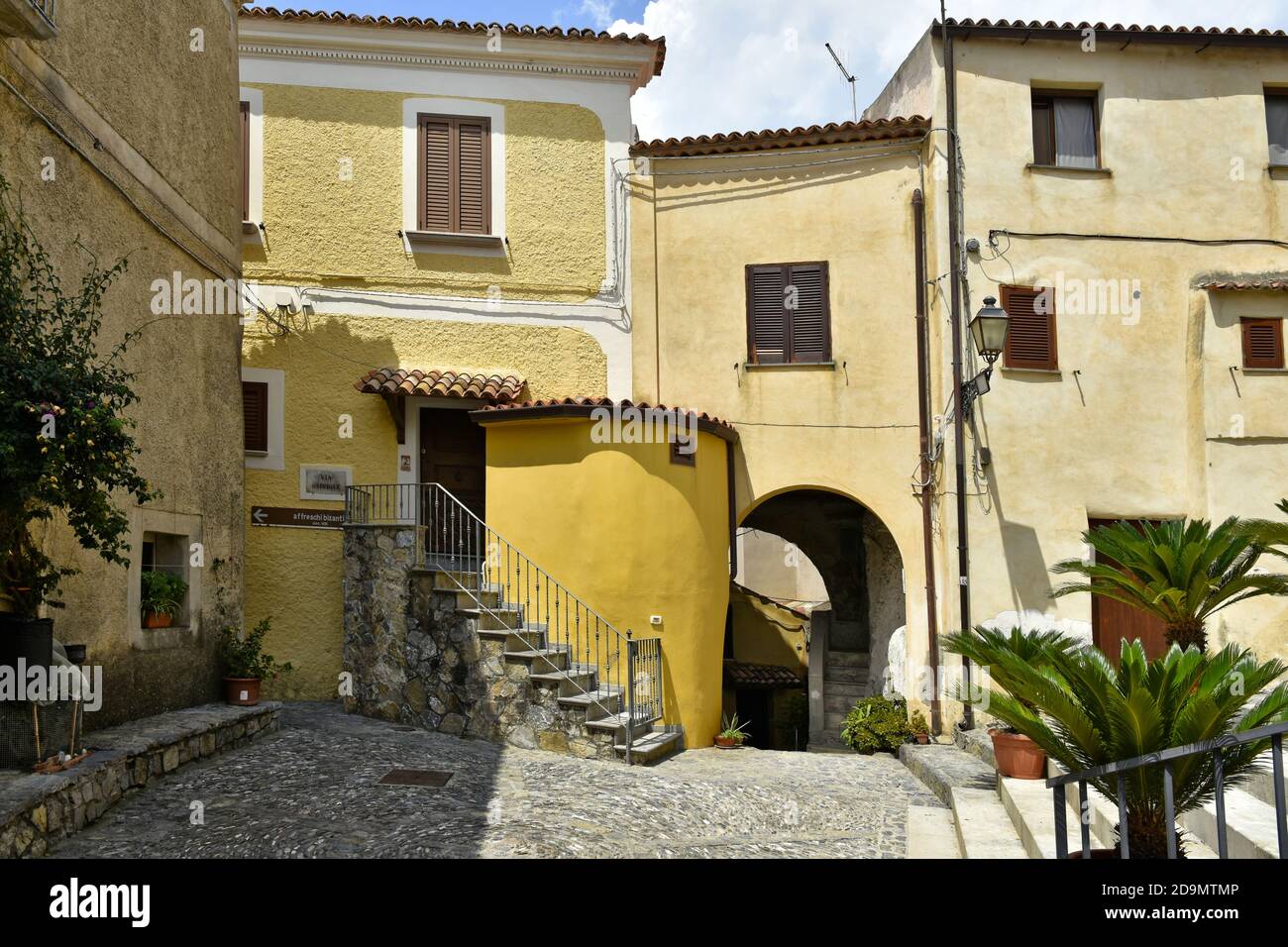 A narrow street among the old houses of Scalea, a rural village in the ...