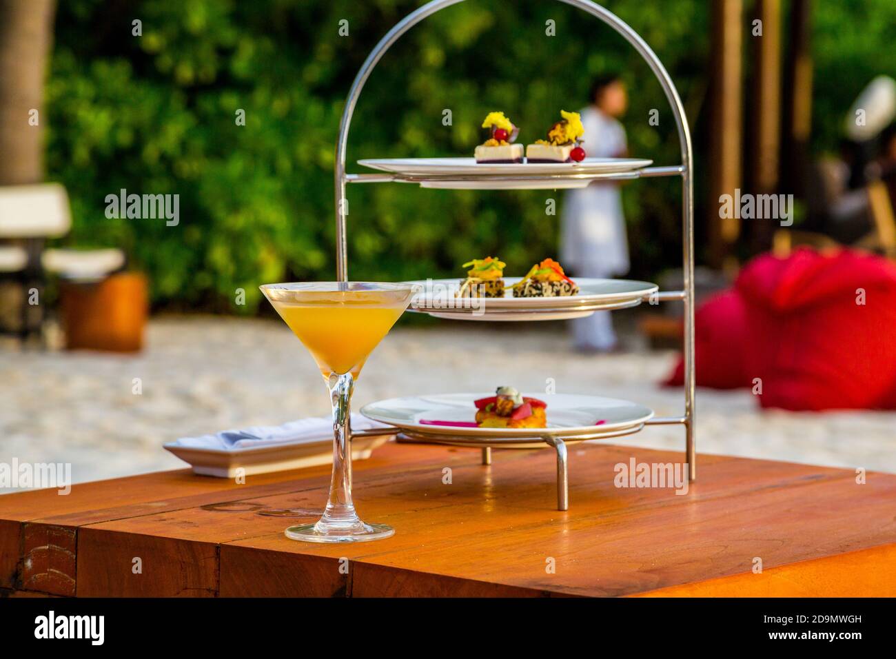 View of cocktails and delicious snacks standing on a wooden table ...