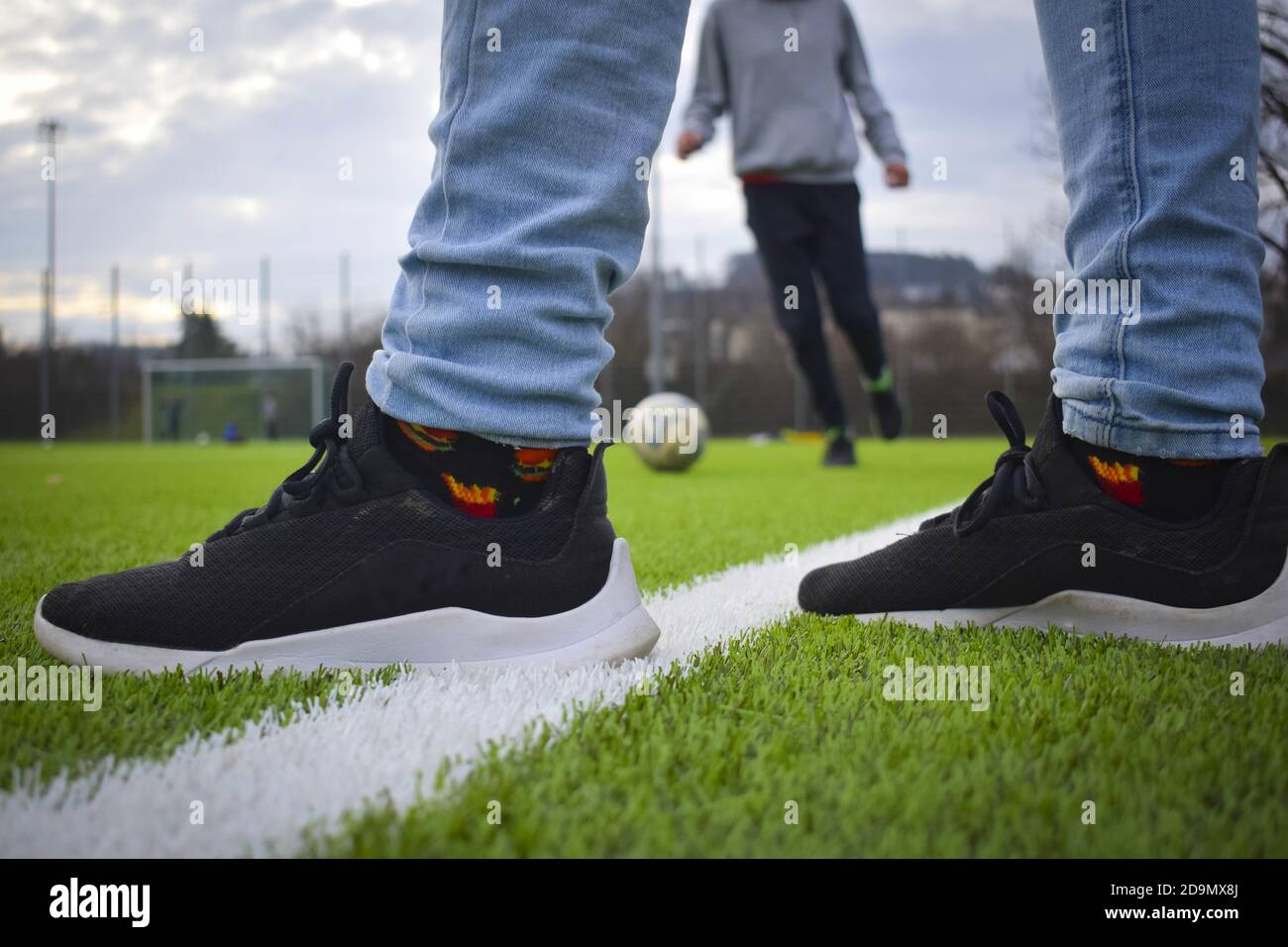Selective focus shot of a male standing on a football stadium Stock ...