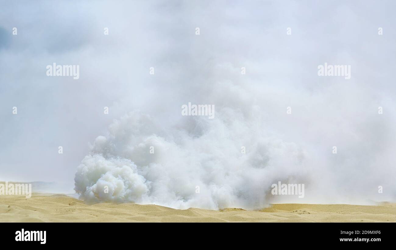 Explosion and clouds of smoke on the sand Stock Photo - Alamy