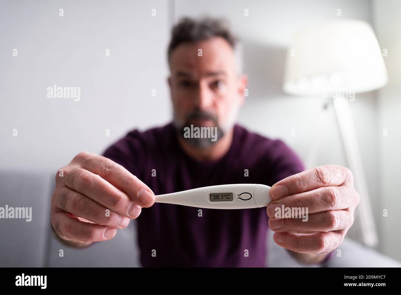 Sick Man With Fever Holding Thermometer Showing High Temperature Stock ...