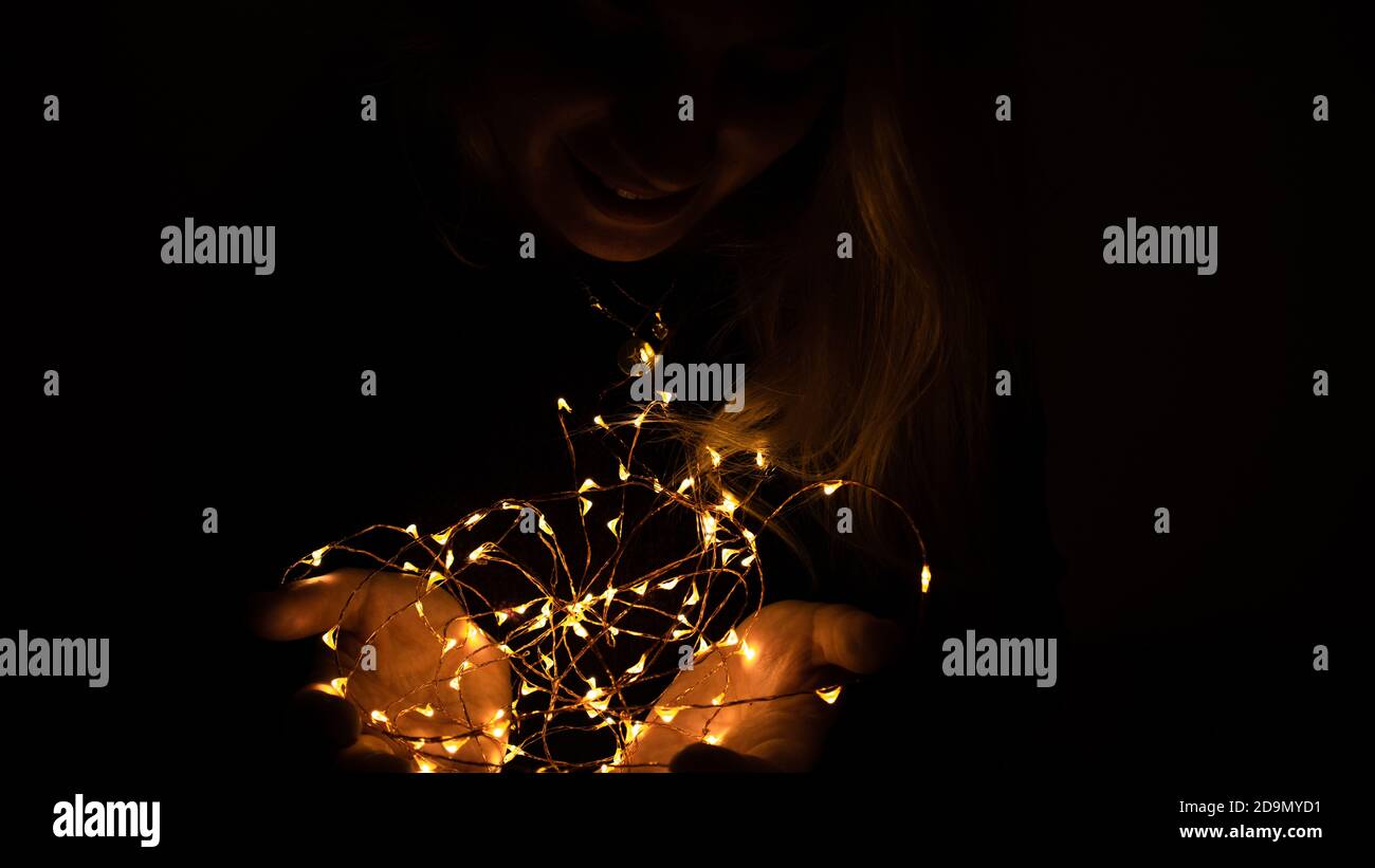 Blonde girl holding lights in her hands Stock Photo - Alamy