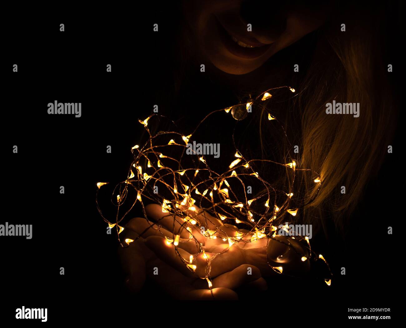 Blonde girl holding lights in her hands Stock Photo - Alamy