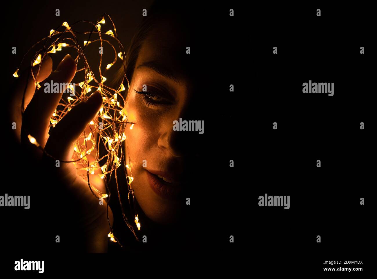 Blonde girl holding lights in her hands Stock Photo - Alamy