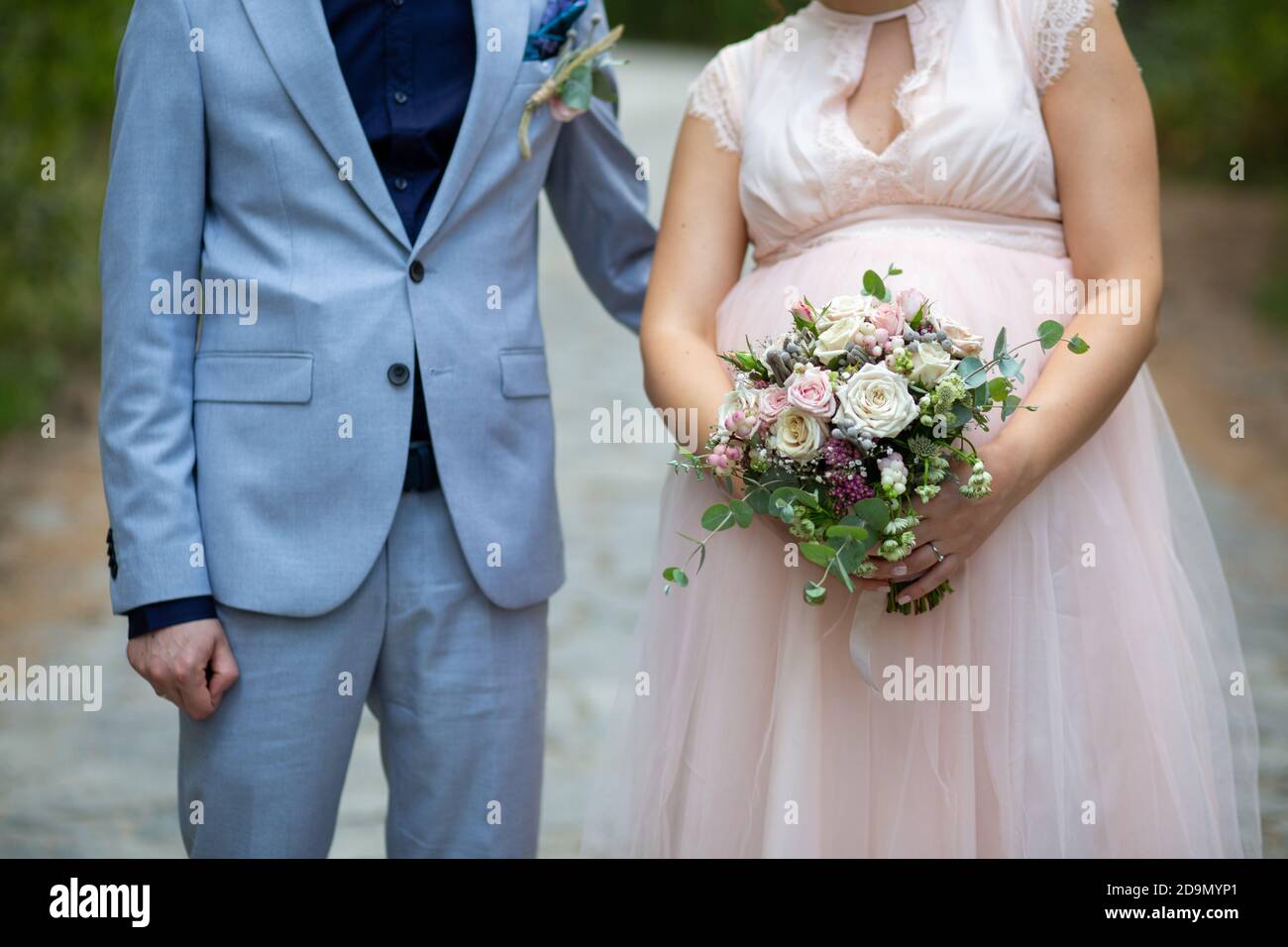 Pregnant bride with the groom on their wedding day Stock Photo - Alamy