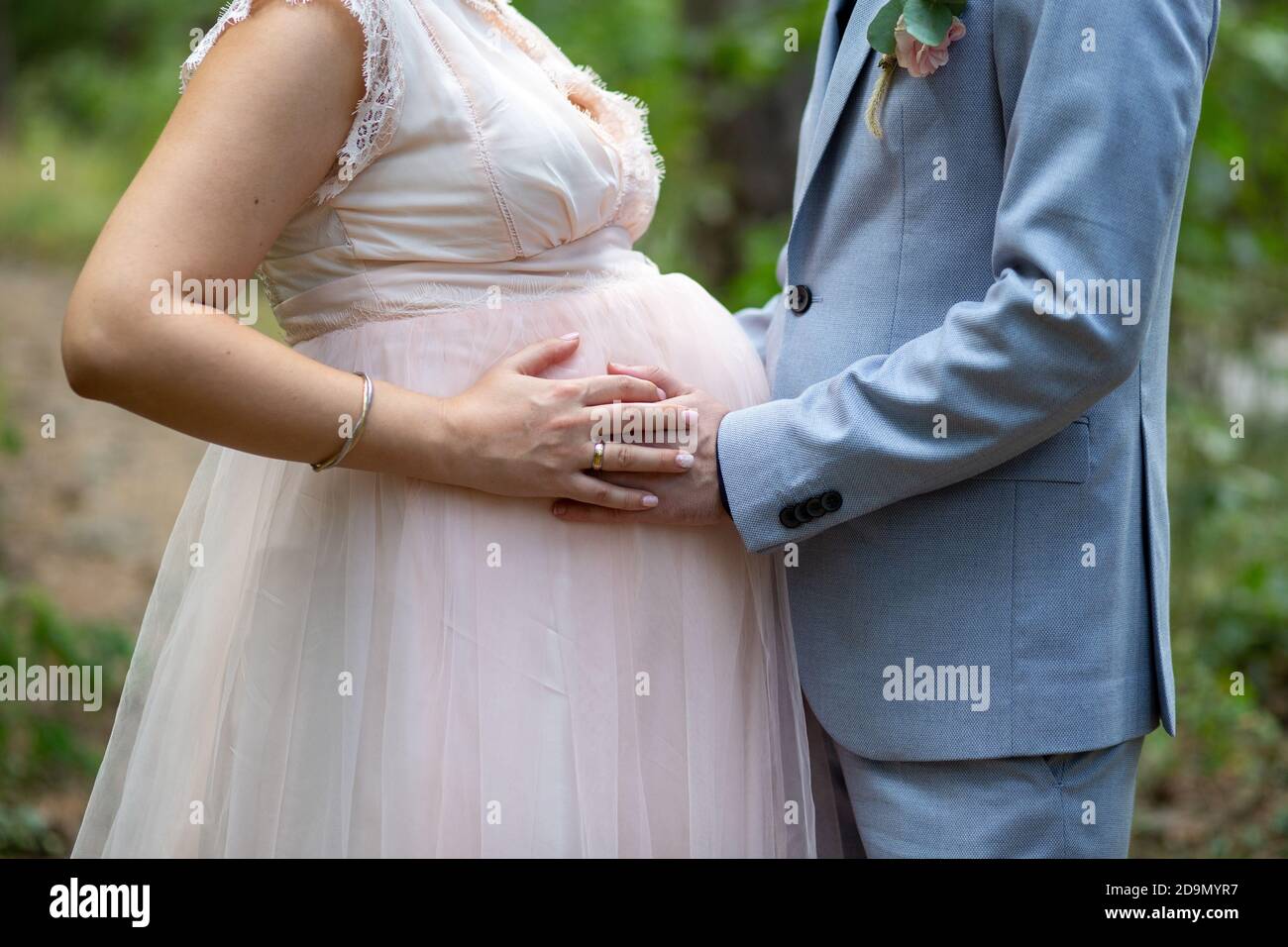 Pregnant bride with the groom on their wedding day Stock Photo - Alamy