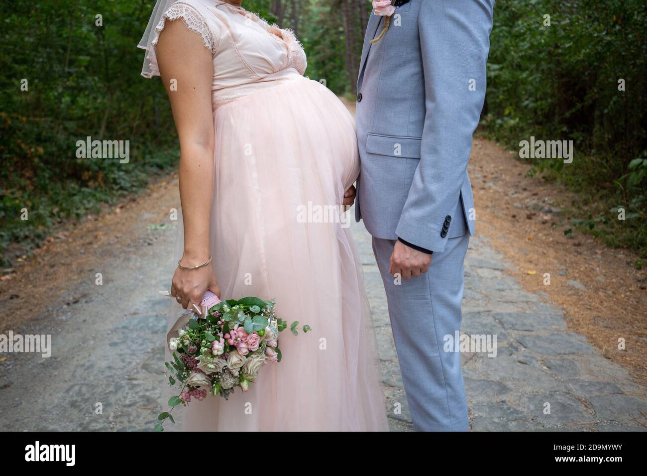 Pregnant bride with the groom on their wedding day Stock Photo - Alamy