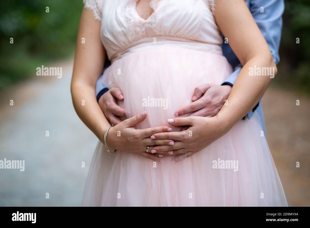 Pregnant bride with the groom on their wedding day Stock Photo - Alamy