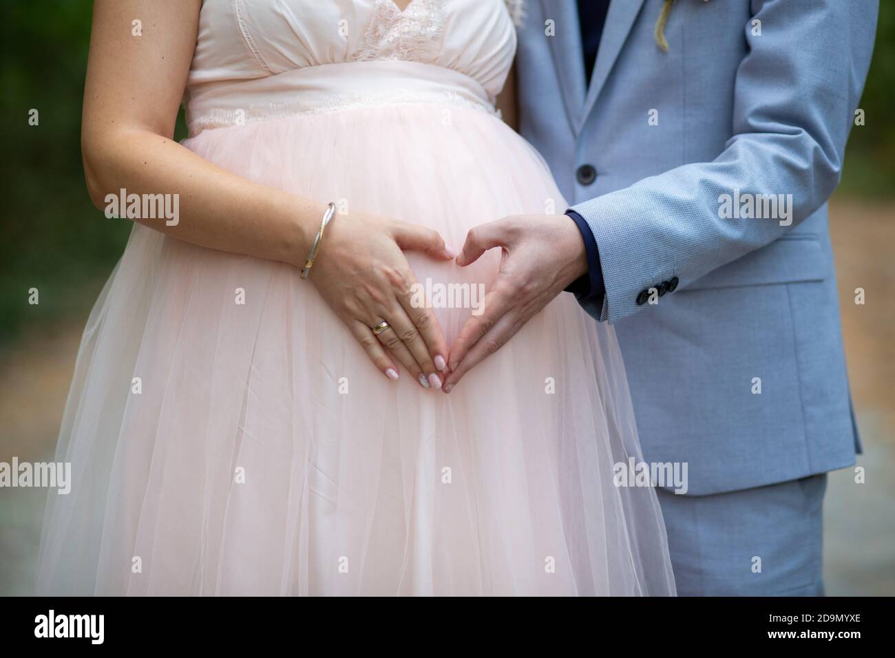 Pregnant bride with the groom on their wedding day Stock Photo - Alamy