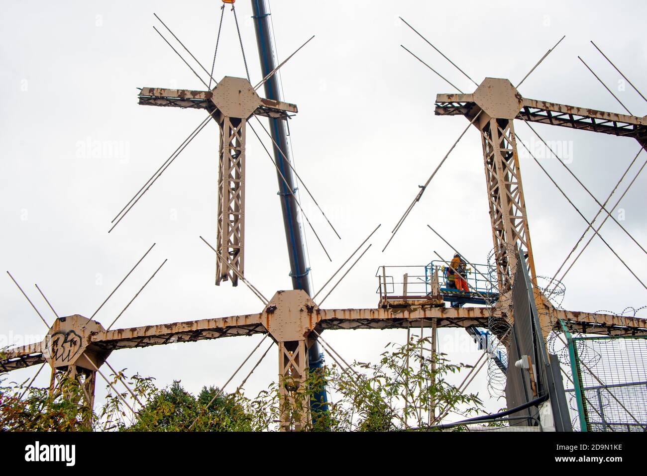 A demolition worker uses an oxy-acetylene torch to cut up a Victorian ...