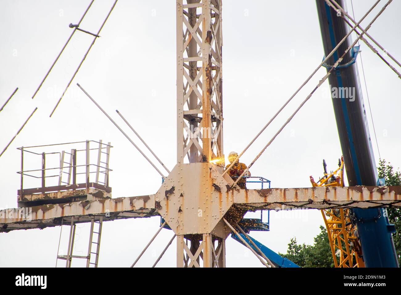 A demolition worker uses an oxy-acetylene torch to cut up a Victorian ...