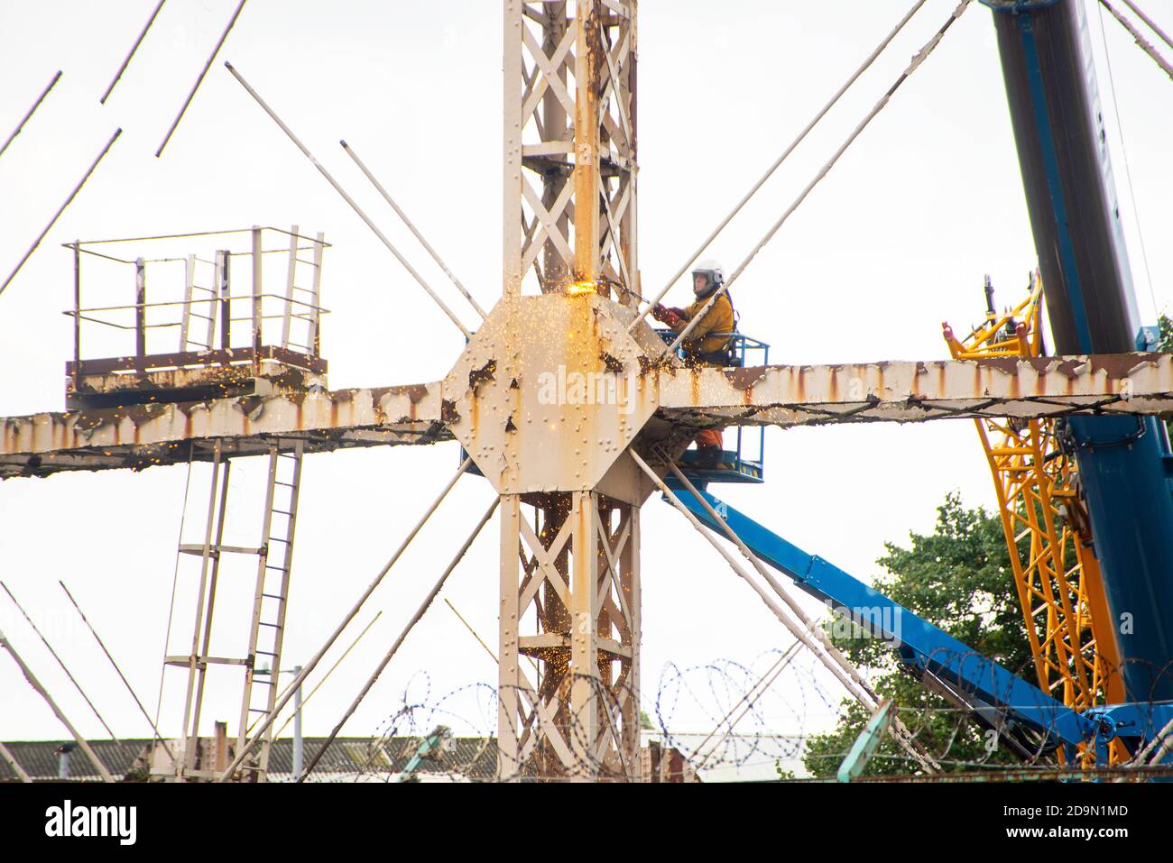 A demolition worker uses an oxy-acetylene torch to cut up a Victorian ...