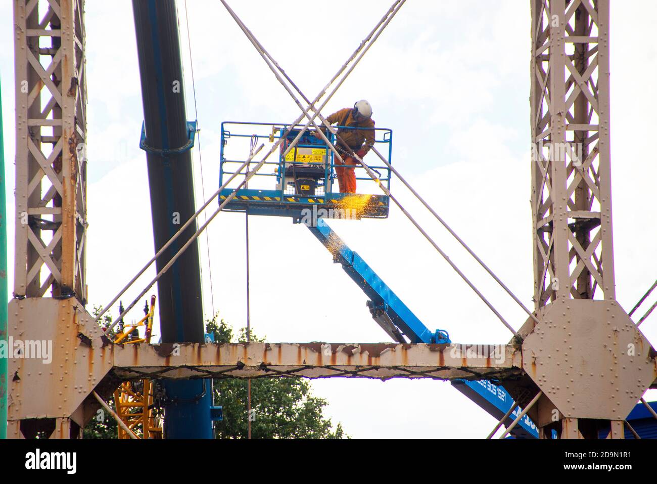 A demolition worker uses an oxy-acetylene torch to cut up a Victorian ...