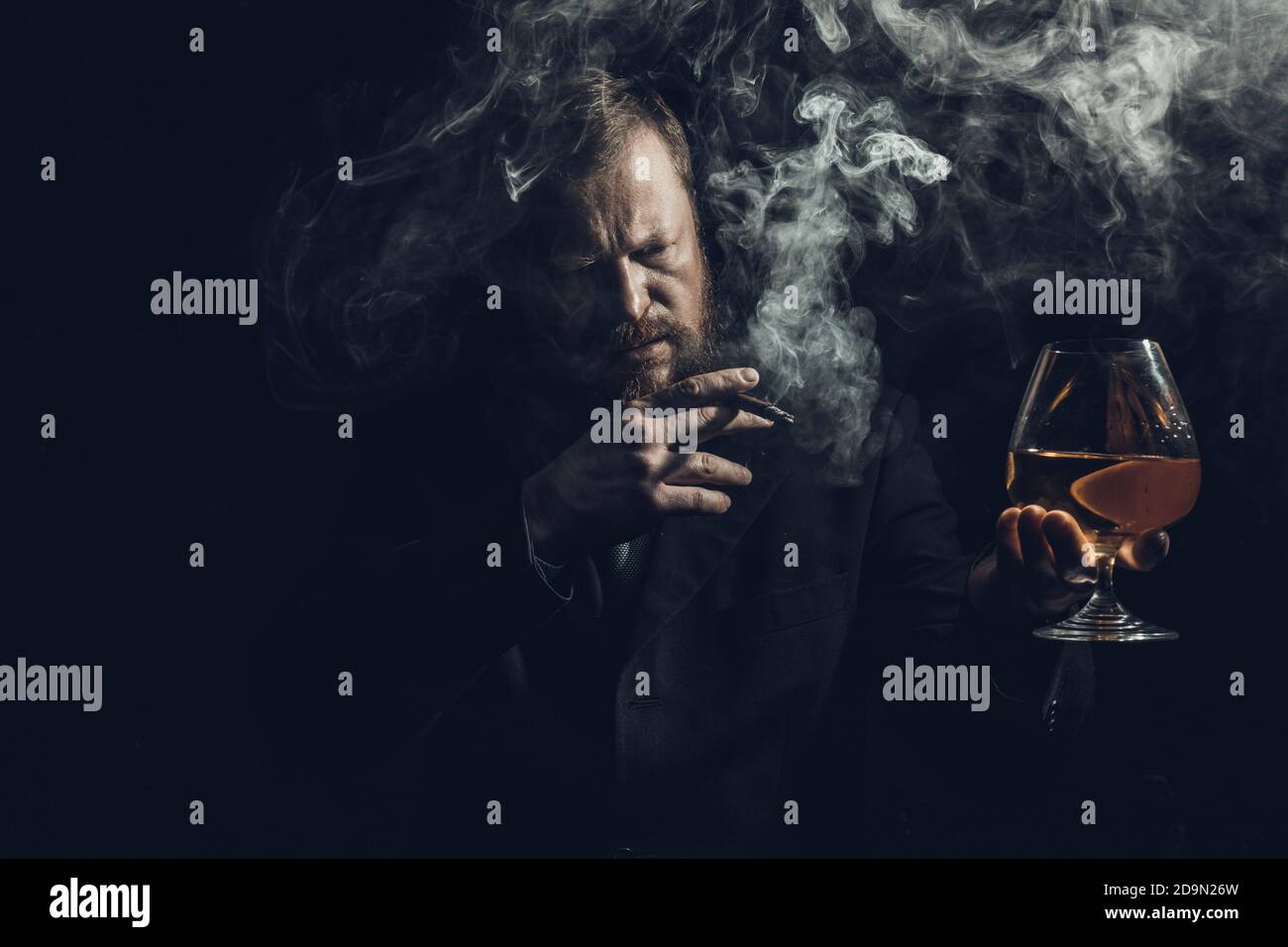 Solid confident bearded man in suit with glass of whisky and cigar with ...
