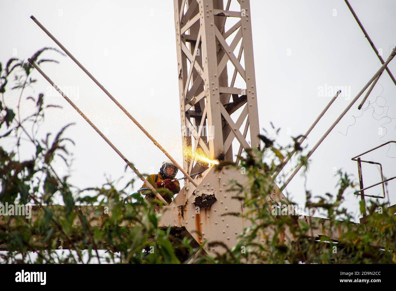 A demolition worker uses an oxy-acetylene torch to cut up a Victorian ...