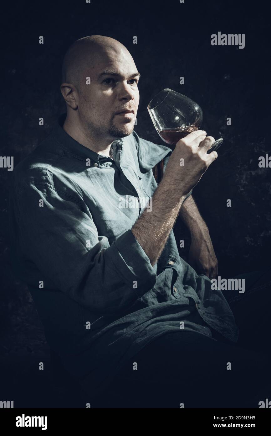 Solid bald man in shirt with glass of whisky studio portrait Stock ...