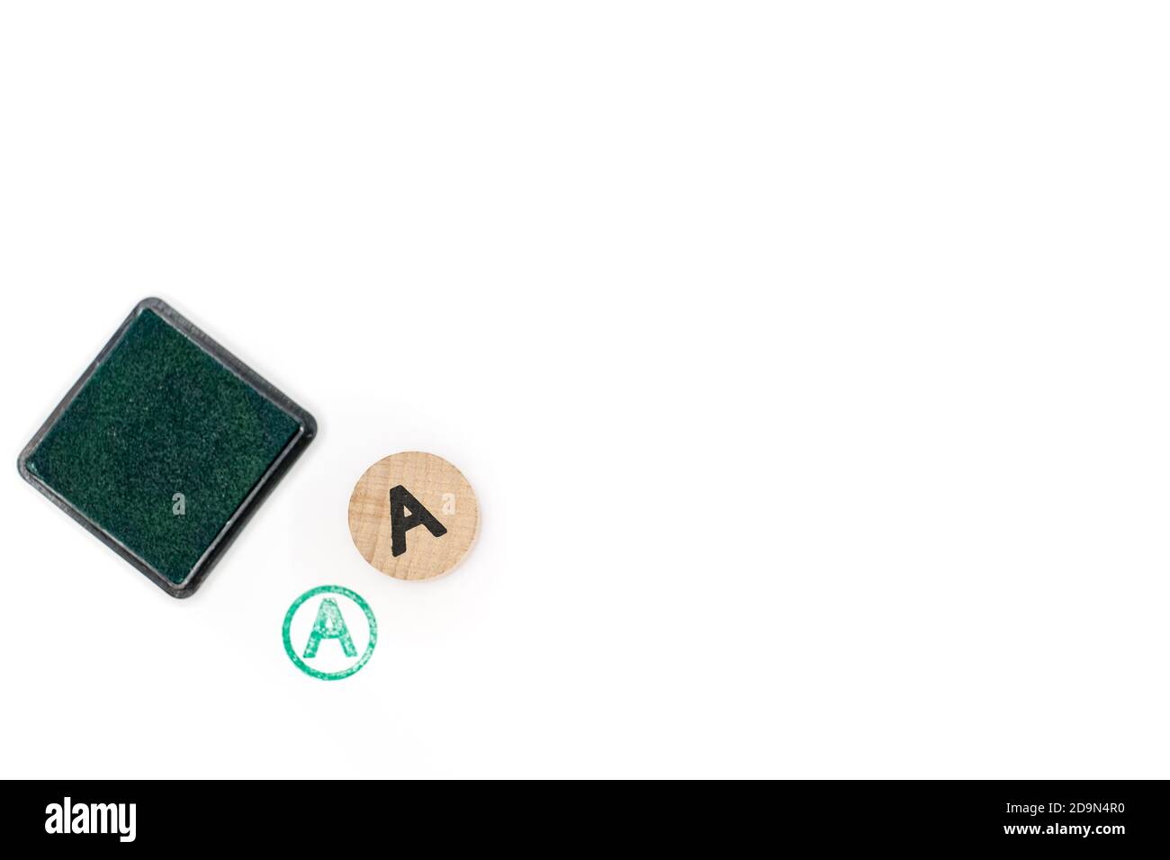 round wooden stamp letter A stamped and pad with green ink Stock Photo ...