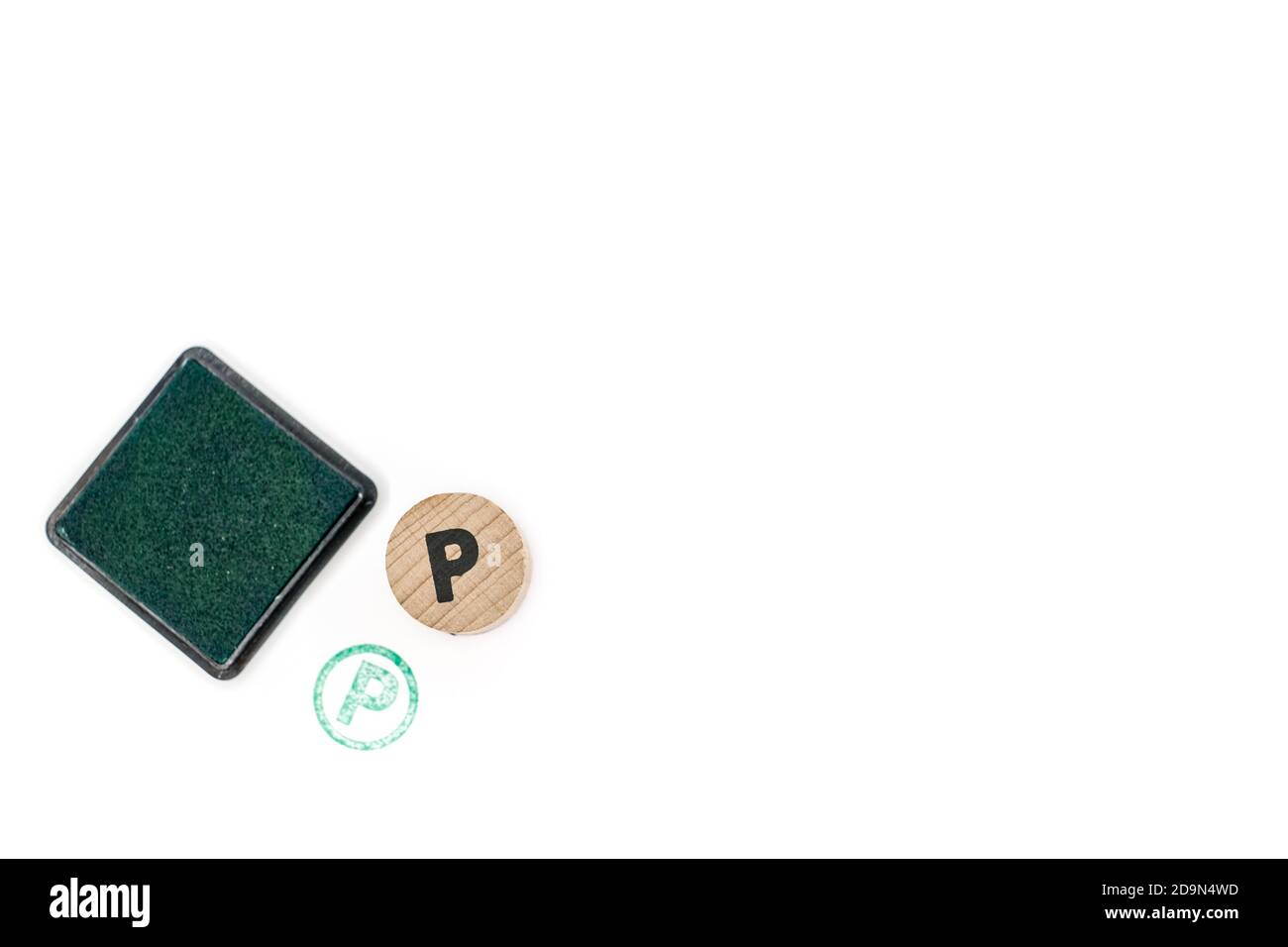 round wooden stamp letter P stamped and pad with green ink Stock Photo ...
