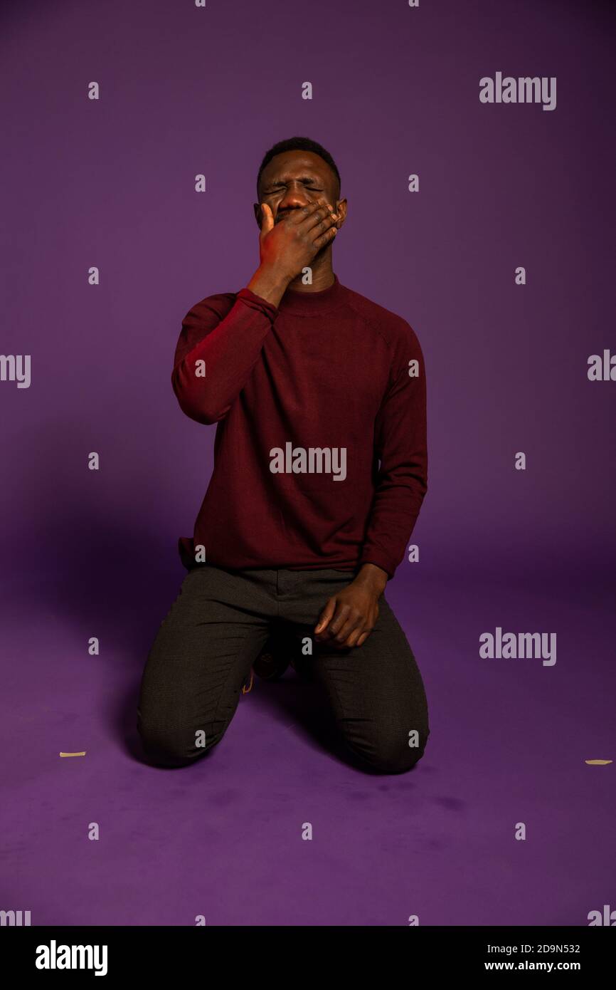 African Man On Knees Crying With Hand Covering Face Full Length Front View Isolated Stock