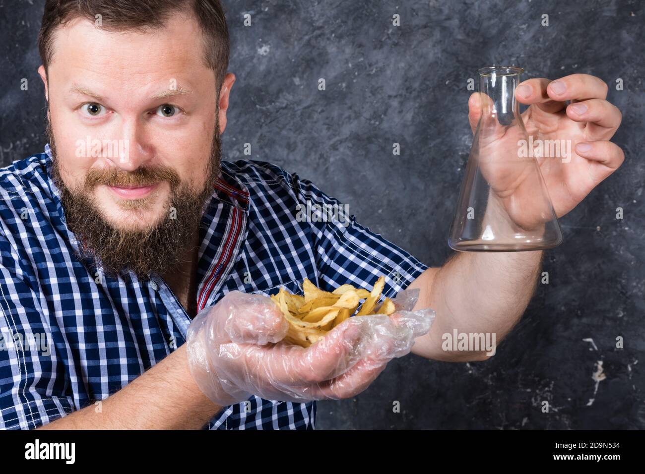 Solid bearded man at casual clothes with heap of chips in one hand and ...