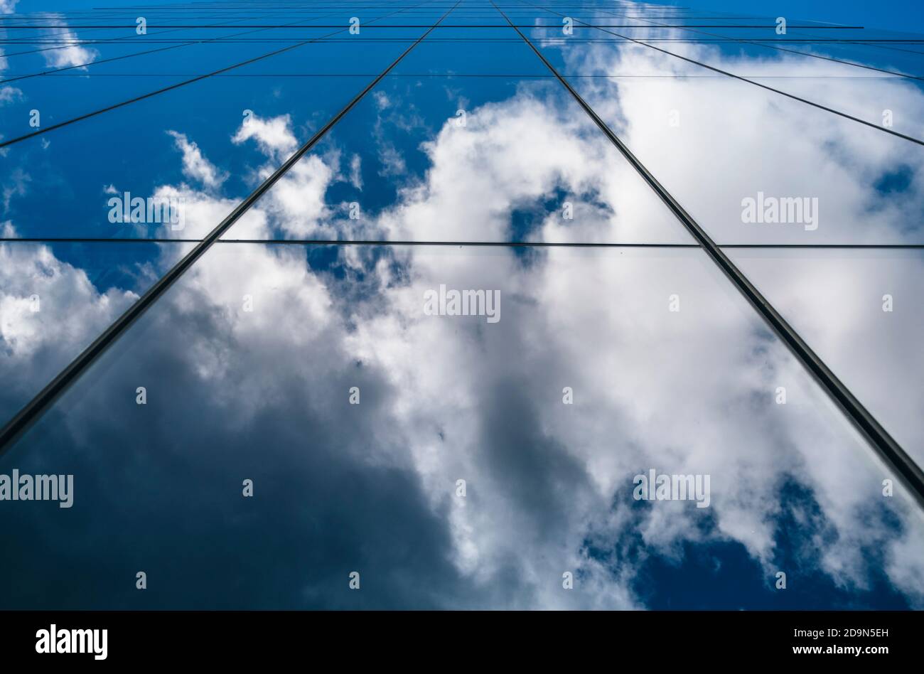 The reflection of the sky on a tall glass building Stock Photo - Alamy